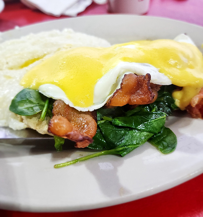 Eggs Benedict gets the Florida treatment with fresh spinach and perfectly crisped bacon. Hollandaise sauce that would make a French chef weep.