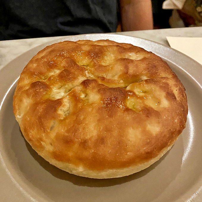 This focaccia isn't just bread; it's a puffy golden cloud that's been kissed by the oven gods and sent to your table as a gift.