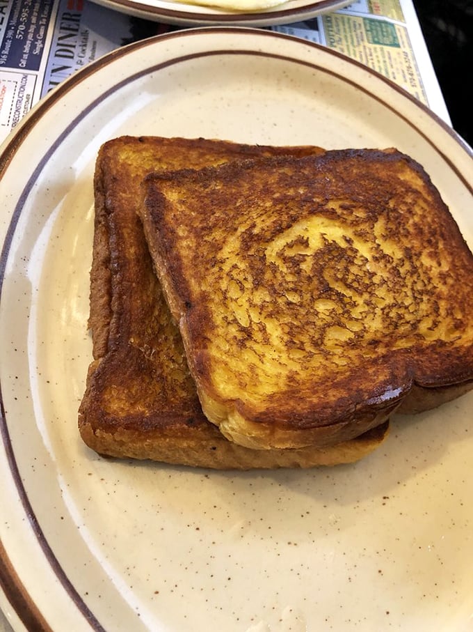 French toast so perfectly golden, it makes you wonder if the griddle has been seasoned with decades of breakfast magic.