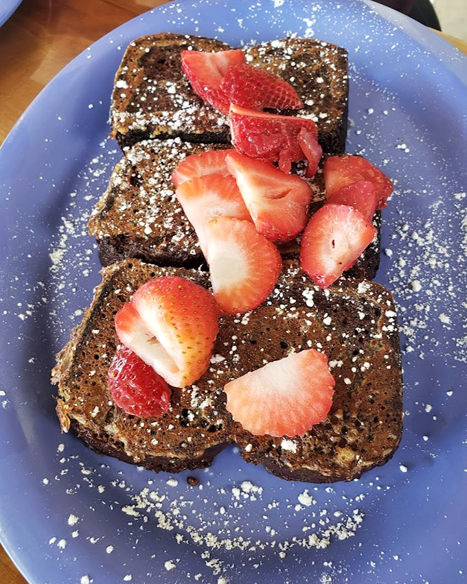 French toast that's had a spa day – exfoliated with cinnamon, moisturized with butter, and adorned with fresh strawberries and powdered sugar.