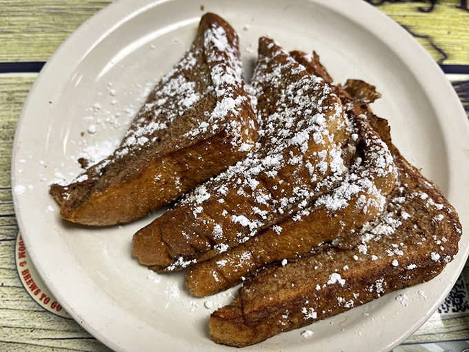 French toast dusted with powdered sugar—simple perfection that makes you wonder why anyone bothers with avocado toast and acai bowls.