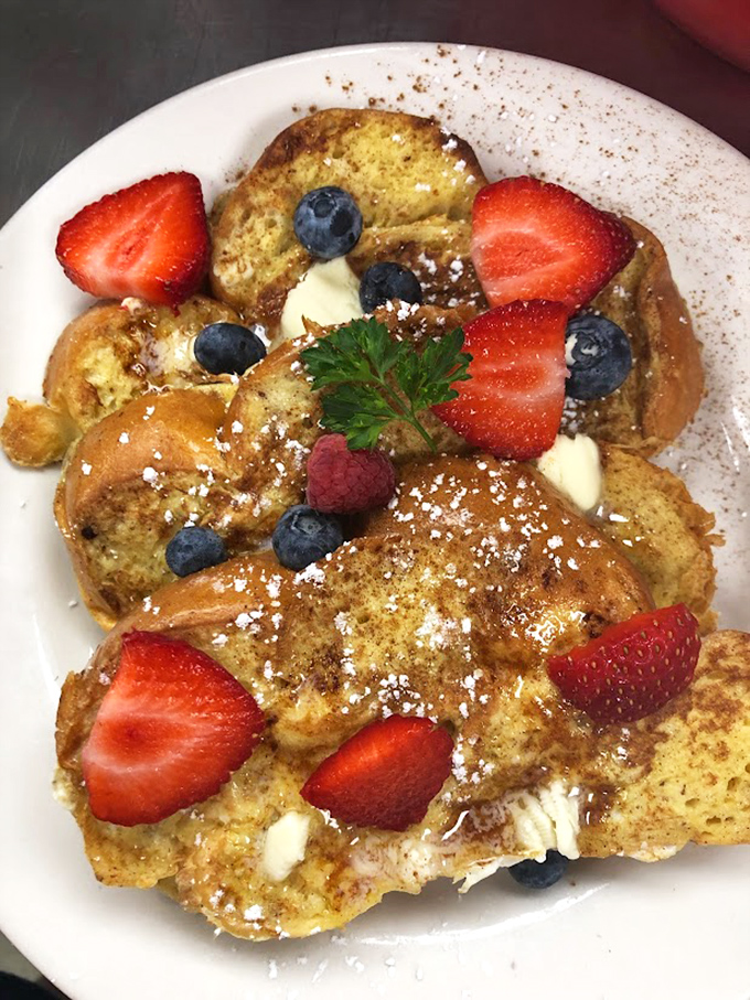 French toast that looks like it's auditioning for a magazine cover. Those berries aren't garnish—they're co-stars in this breakfast blockbuster.