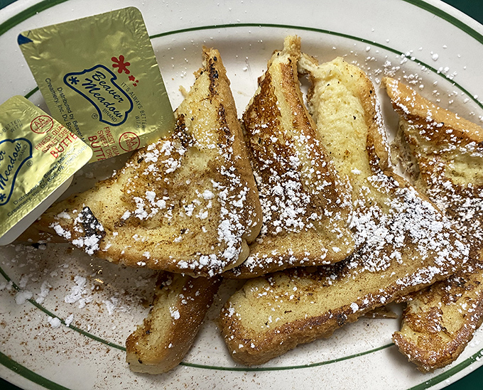 French toast triangles that would make France jealous &ndash; crispy edges, custardy centers, and enough powdered sugar to leave evidence on your shirt.