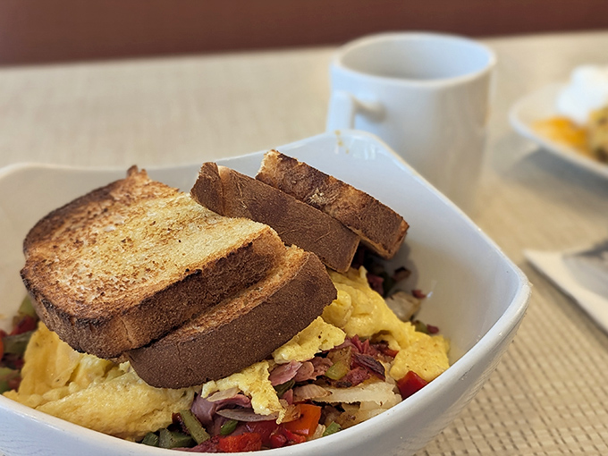 This hearty breakfast scramble nestled between toast slices isn't just a meal &ndash; it's armor against whatever Michigan weather decides to throw at you today.