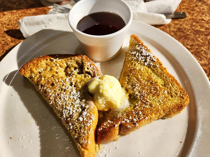 French toast that makes you question why you ever settled for lesser versions. That dusting of powdered sugar? The breakfast equivalent of fairy dust. 