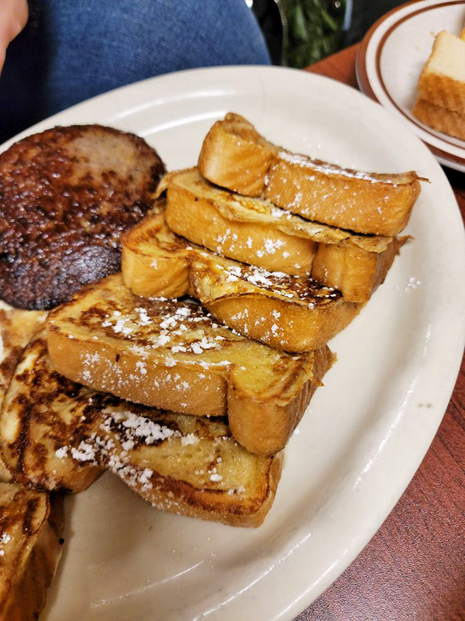 French toast that would make your grandmother both proud and jealous. That dusting of powdered sugar? Pure breakfast magic.