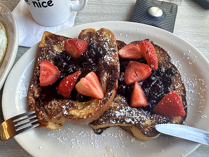 Challah French toast that transforms breakfast into dessert without apology. Those berries are just there to make you feel virtuous.