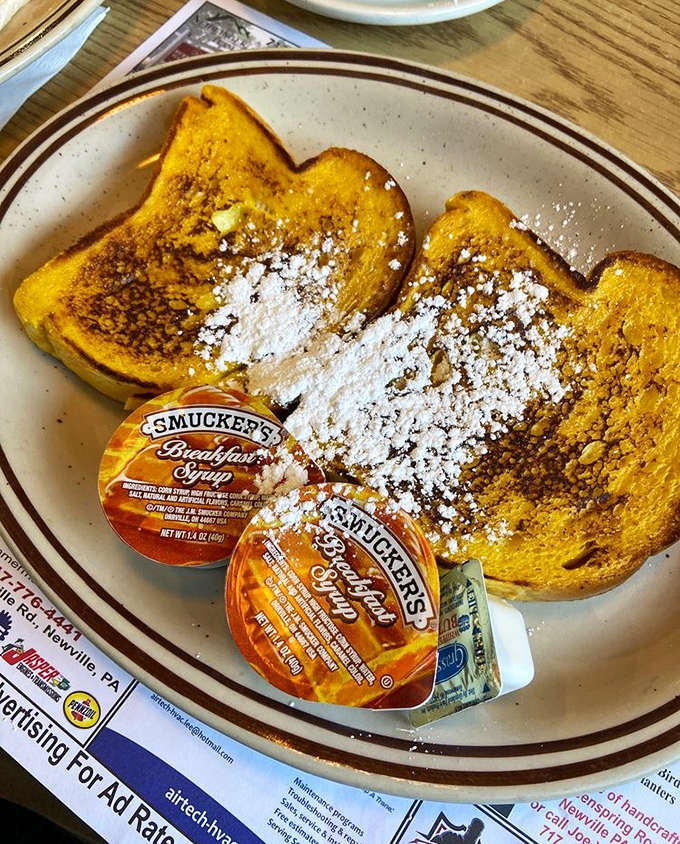French toast dusted with powdered sugar like the first perfect snowfall of winter. Those Smucker's syrup packets&mdash;the universal language of American breakfast.