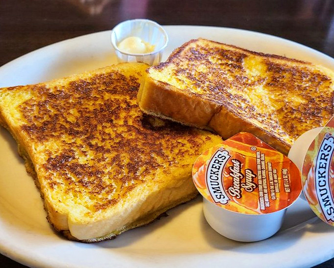French toast that arrives looking like it graduated summa cum laude from breakfast university with honors in deliciousness.
