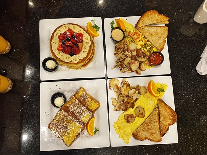 The breakfast quartet in perfect harmony &ndash; golden pancakes topped with fresh fruit, French toast dusted with powdered sugar, and eggs cooked just right.