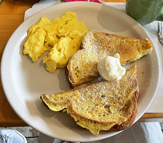 Golden French toast dusted with powdered sugar alongside fluffy scrambled eggs&mdash;proof that sometimes the simplest pleasures are the most profound.