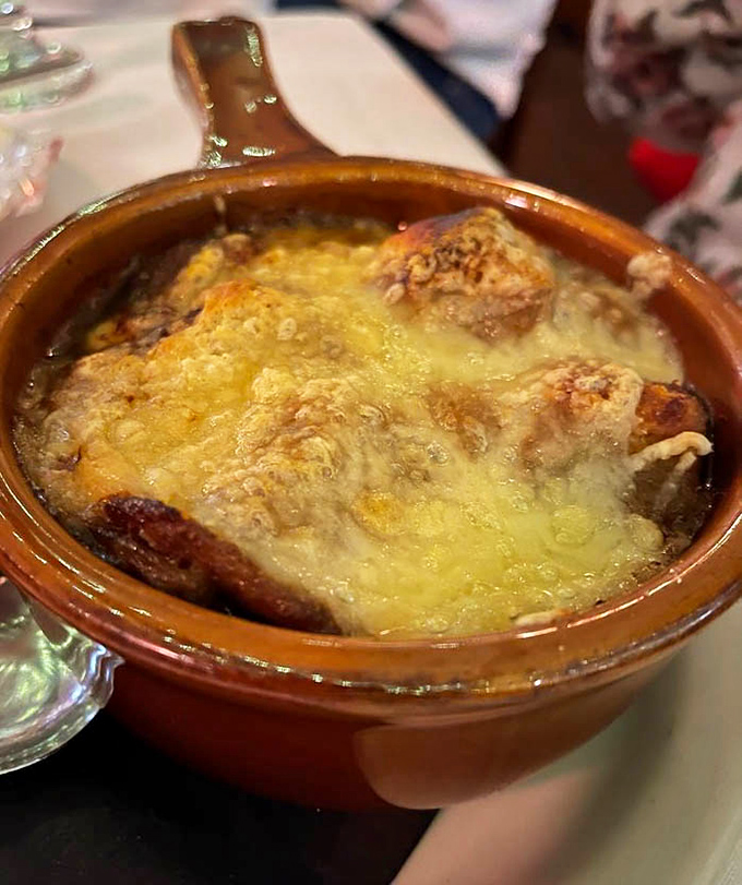 Bubbling cheese stretching skyward like it's trying to high-five your taste buds. This French onion soup isn't just comfort food&mdash;it's a warm hug in a crock.