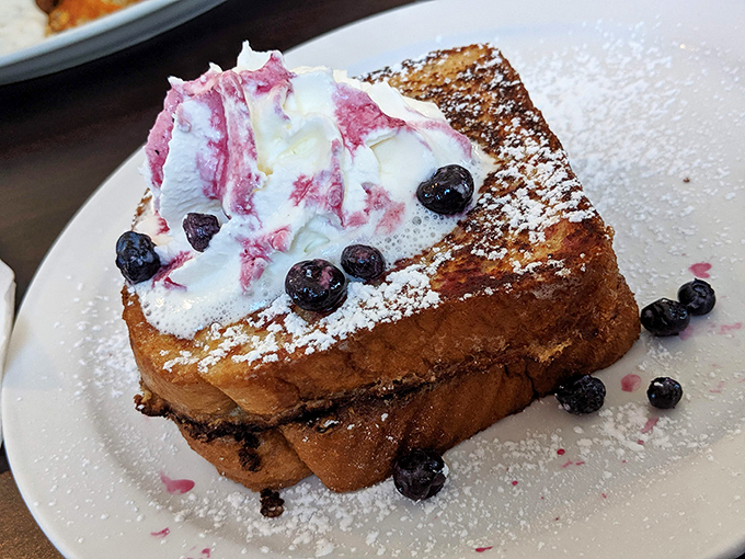 French toast that's gone to finishing school &ndash; crisp edges, custardy center, and topped with berries and cream that make breakfast feel like dessert.