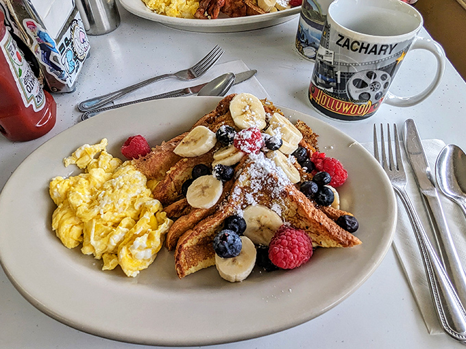 French toast that could make a Parisian jealous, crowned with fresh berries and bananas. Notice the Hollywood souvenir mug &ndash; part of Eddie's charming mismatched collection.