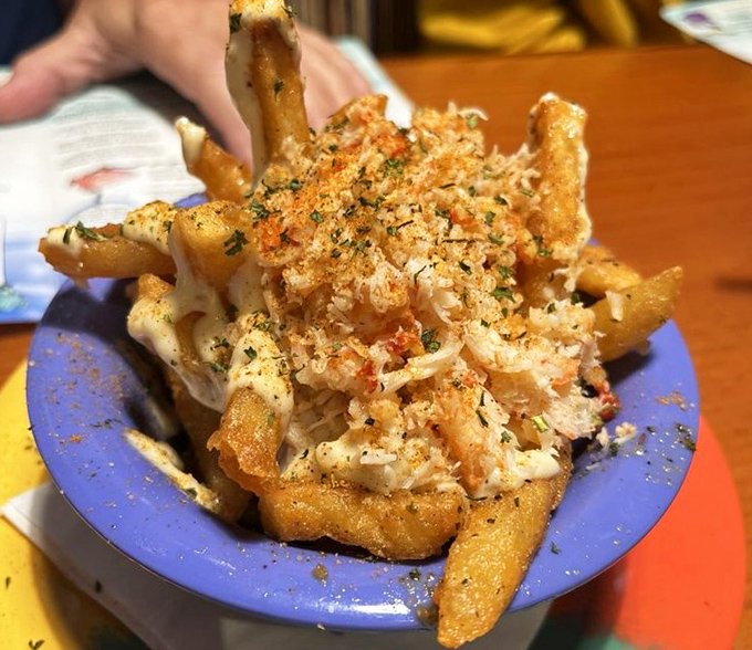 Garlic crab fries that prove sometimes the best ideas happen when someone says "what if we combined everything delicious?"