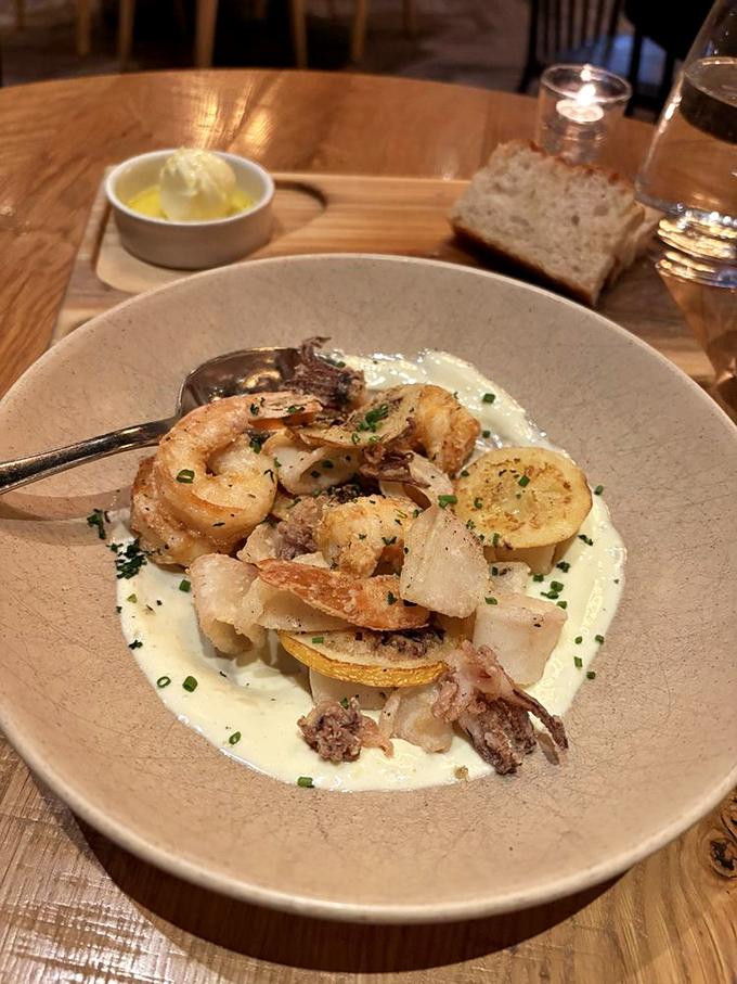 Seafood that speaks for itself—plump shrimp and tender calamari nestled in a creamy sauce that begs to be sopped up with bread.