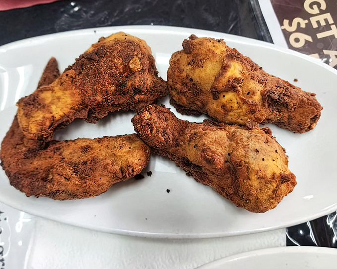 Fried chicken so perfectly golden it should come with its own trophy. That seasoned crust is keeping secrets that only your taste buds can unlock.