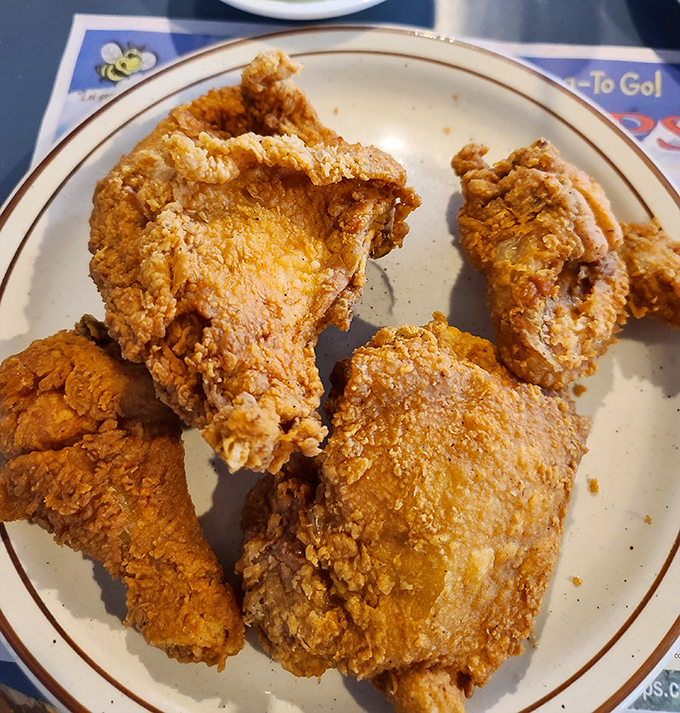 Fried chicken so golden it deserves its own Fort Knox. The kind of crust that makes that perfect crackle sound when your fork breaks through.