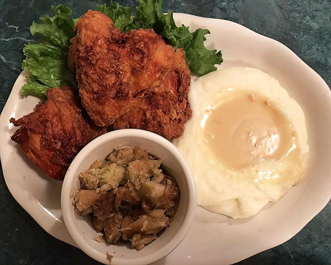 Fried chicken with a golden crust that audibly shatters with each bite, alongside mashed potatoes that could make a grown person weep with joy.