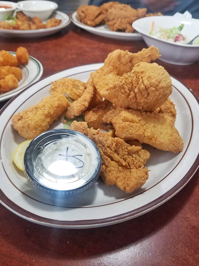Golden-battered fried chicken that crunches like autumn leaves, revealing juicy meat that makes you close your eyes in silent appreciation.