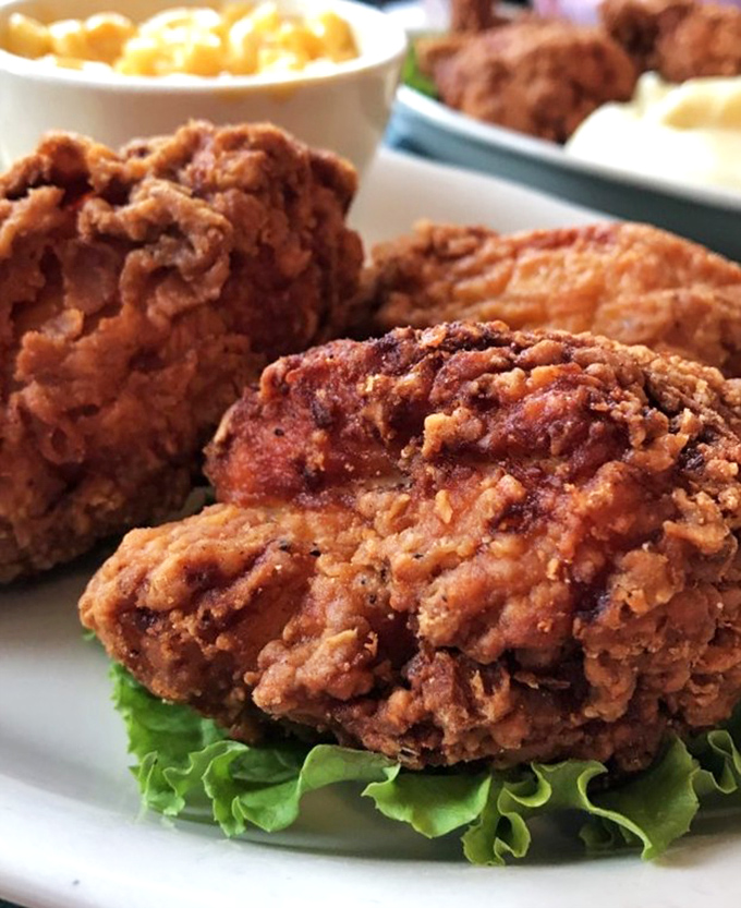 Fried chicken so perfectly golden and crispy, it makes the Colonel look like he's still in basic training. That crust could win awards.