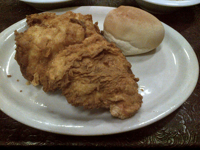 Fried chicken that's audibly crunchy on the outside, juicy on the inside, and served with a dinner roll that's clearly been taking its carb responsibilities seriously.
