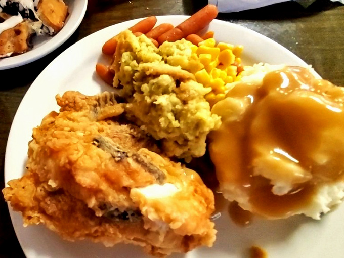 The holy trinity of rural Missouri dining: golden fried chicken, buttery corn, and mashed potatoes swimming in gravy that could solve most of life's problems.