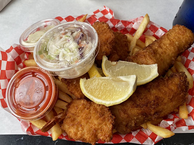 Golden-battered fish that crunches louder than saddle shoes on a gymnasium floor, served with fries that deserve their own fan club.