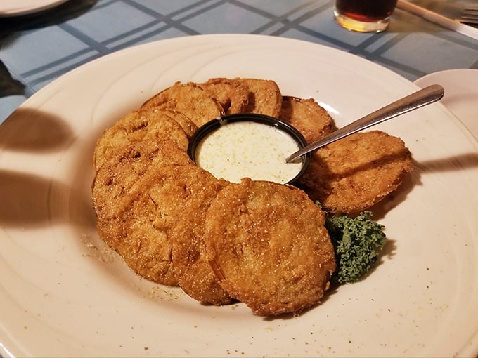 Golden-brown fried green tomatoes arranged like a delicious clock face, with dipping sauce standing by for its supporting role.