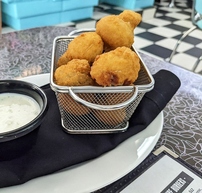 Golden-fried mushrooms that crunch like autumn leaves, served in a miniature basket that says "yes, this is exactly what you need."