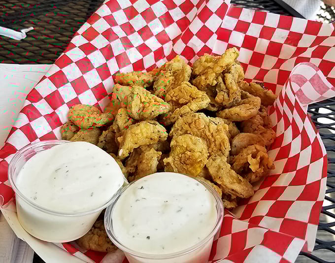 Golden-fried pickle chips that achieve the impossible: maintaining their crunch while delivering that perfect tangy-salty punch that makes you reach for "just one more."