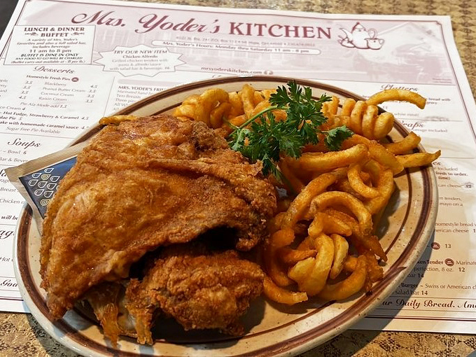 Fried chicken so perfectly golden it deserves its own trophy, paired with curly fries that put regular fries to shame.