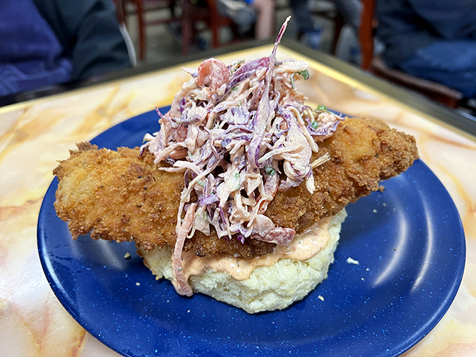This isn't just fried chicken&mdash;it's a masterpiece of crunch atop a cloud-like biscuit, crowned with homemade slaw. Your diet doesn't stand a chance.