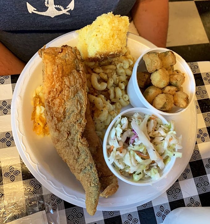 Perfectly fried fish with mac and cheese, hushpuppies, and coleslaw &ndash; a plate that makes you want to send a thank-you note to whoever invented breading.