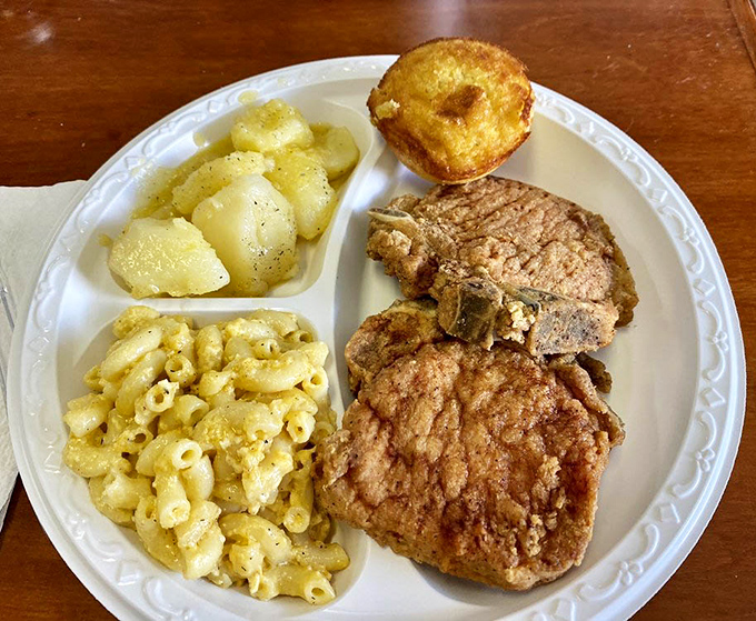 Southern harmony in three parts: crispy pork chop, buttery cornbread, and sides that don't know the meaning of "afterthought."