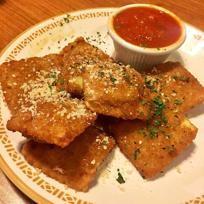 Golden-fried ravioli squares that crunch like autumn leaves but taste like heaven's appetizer course.