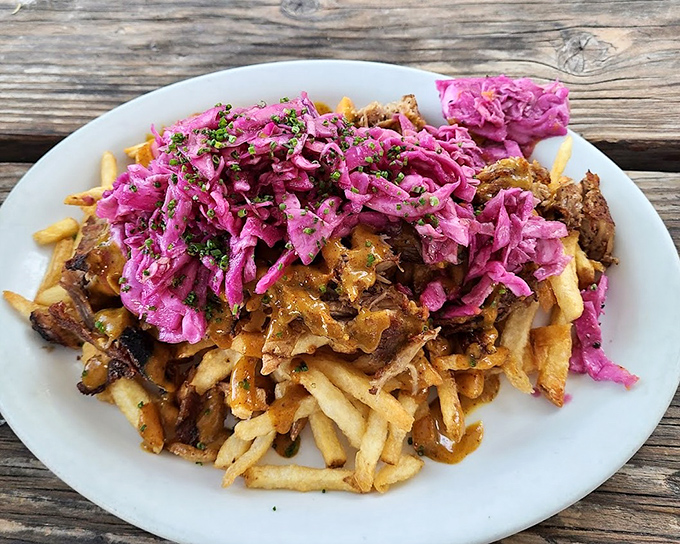 These aren't just fries&mdash;they're a canvas for pulled pork and vibrant purple slaw, creating a technicolor flavor party that puts regular fries to shame.
