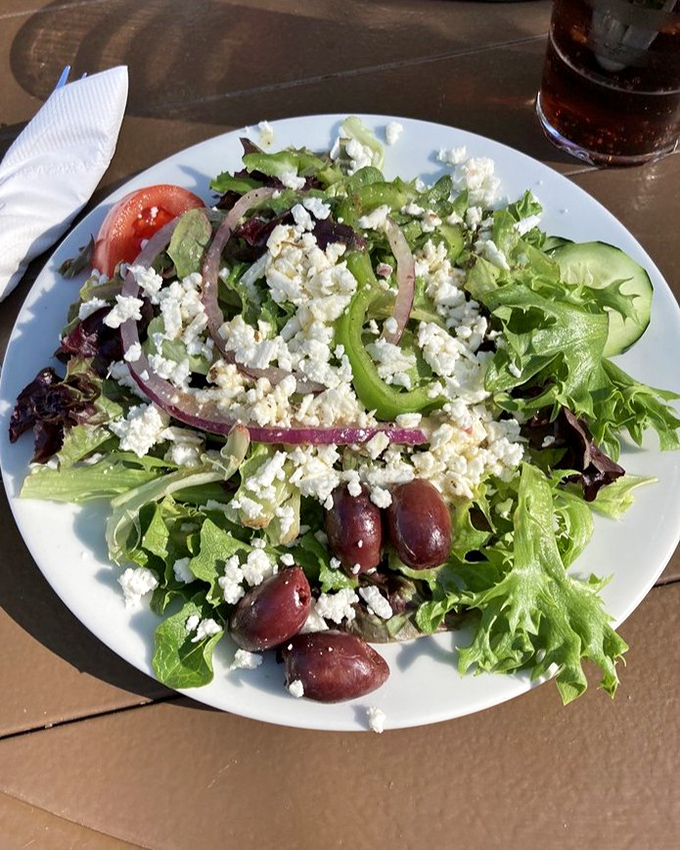 A proper Greek salad that respects the classics&mdash;crisp greens, briny olives, and generous feta chunks that haven't been hiding in the refrigerator for weeks.