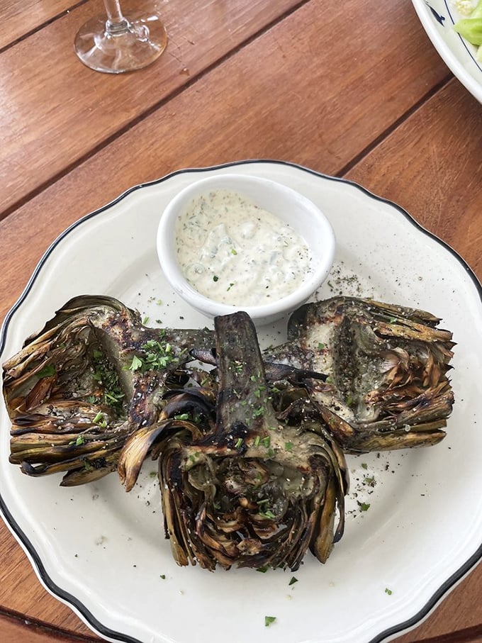 Grilled artichokes&mdash;nature's edible puzzle&mdash;transformed by fire and served with a dipping sauce worth bottling and taking home.