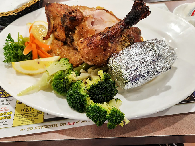 This isn't just dinner; it's a celebration on a plate with roasted chicken, vibrant vegetables, and a baked potato wrapped like a precious gift.