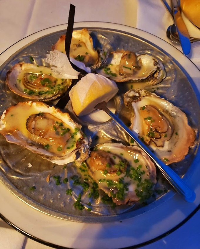 These oysters aren't just seafood—they're little oceanic miracles, glistening on the half shell and begging to be savored one by one.