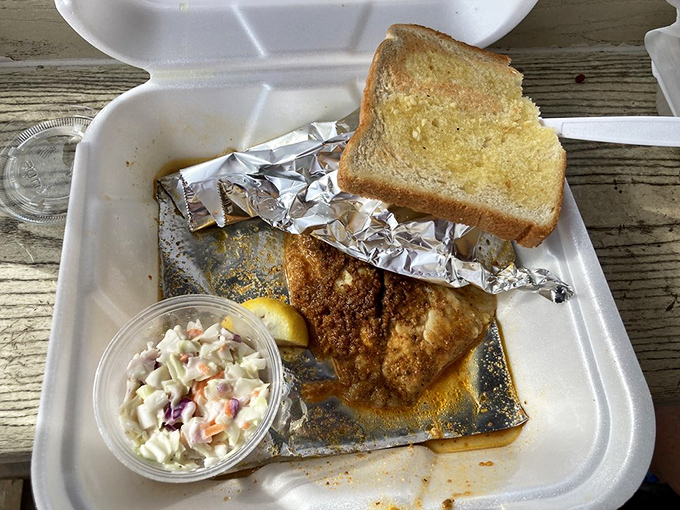 Tilapia gets the royal treatment &ndash; perfectly seasoned, served with garlic toast and coleslaw in a humble foam container fit for seafood royalty.