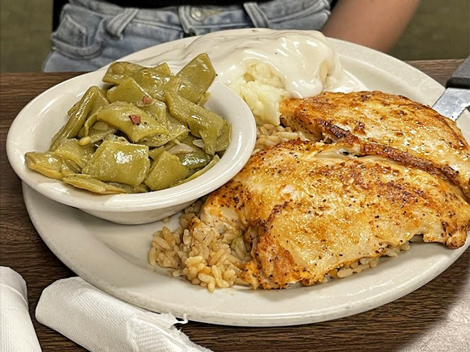 Grilled tilapia with green beans that spent quality time with bacon—proof that healthy-ish options can still speak fluent Southern.
