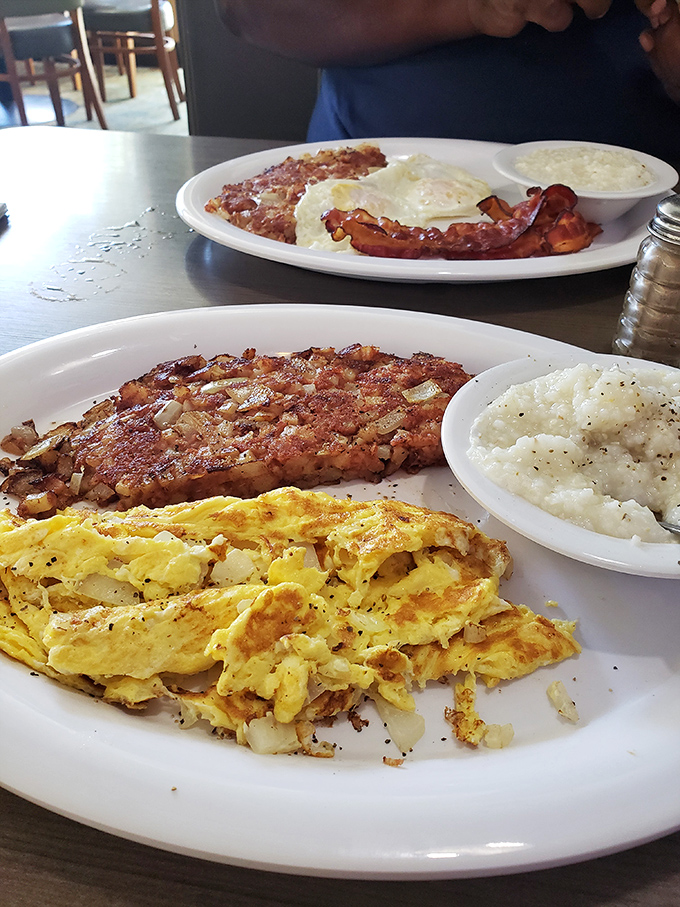The holy trinity of breakfast: perfectly scrambled eggs, crispy hash browns, and bacon cooked exactly how the breakfast gods intended.
