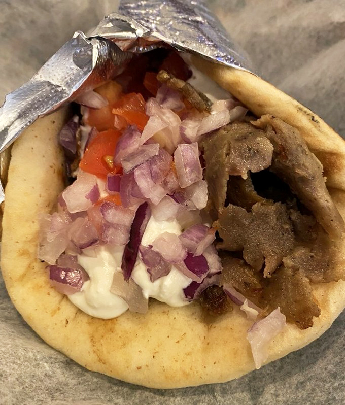 The gyro that launched a thousand cravings. Tender meat, fresh veggies, and tzatziki sauce that would make Zeus himself weep with joy.