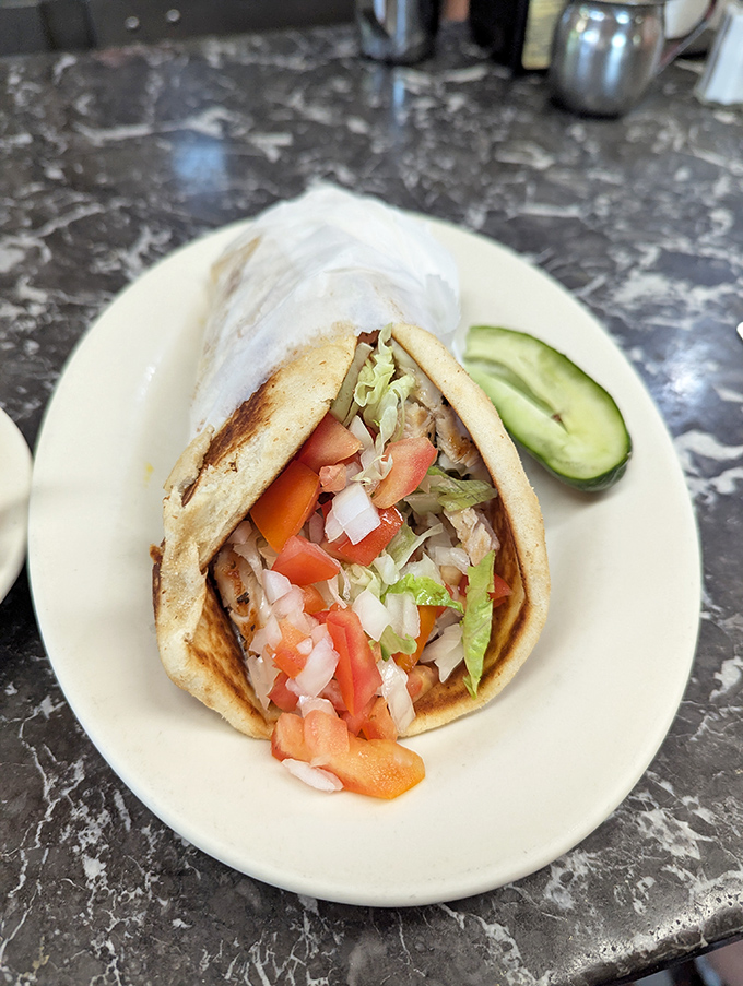 The humble gyro&mdash;Greece's gift to American diners&mdash;bursting with fresh veggies and savory meat in a warm pita embrace.