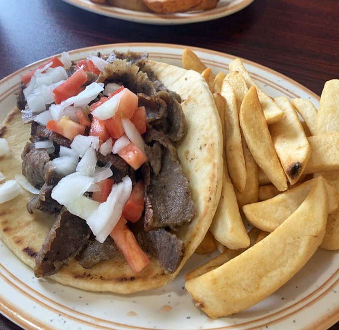 This isn't just a gyro&mdash;it's a Mediterranean vacation on a plate. Fresh toppings, seasoned meat, and those steak fries that somehow make everything better.