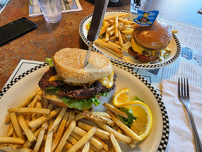 These burgers don't just satisfy hunger&mdash;they conquer it. Served with a mountain of golden fries and that signature checkered plate rim.
