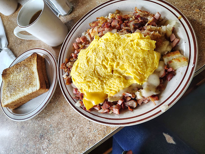 A breakfast skillet that means business&mdash;golden eggs crowning a kingdom of potatoes, ham, and cheese. The kind of morning fuel that makes alarm clocks almost forgivable.