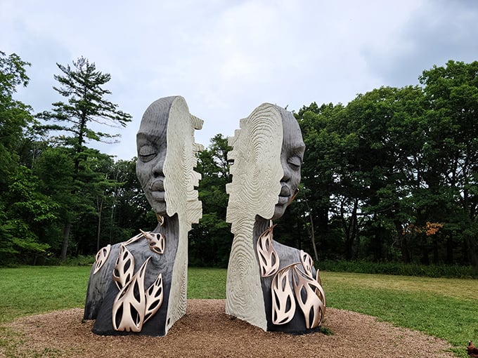 Two faces, one conversation. This split sculpture seems to ask, "Are we separate from nature, or just two halves of the same whole?"